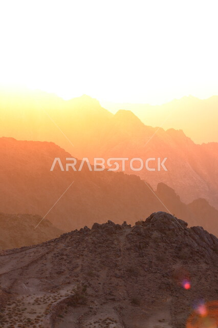 Orange sunset view over Al Faqra mountain range, landmarks and tourist ...