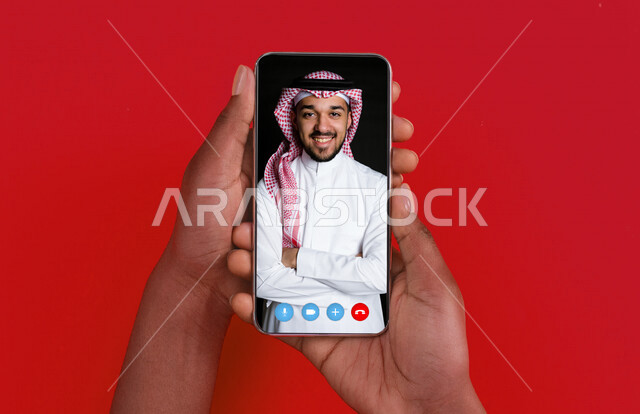 A close-up of a mobile phone with a picture of a Saudi Arabian Gulf ...