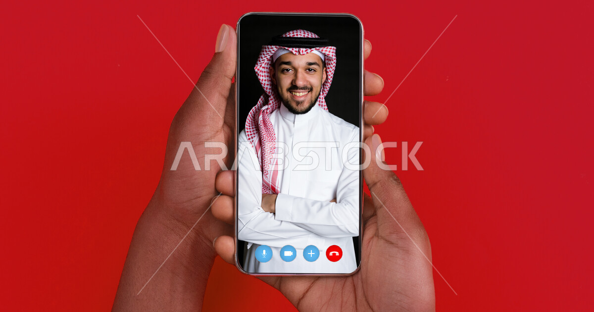 A close-up of a mobile phone with a picture of a Saudi Arabian Gulf ...