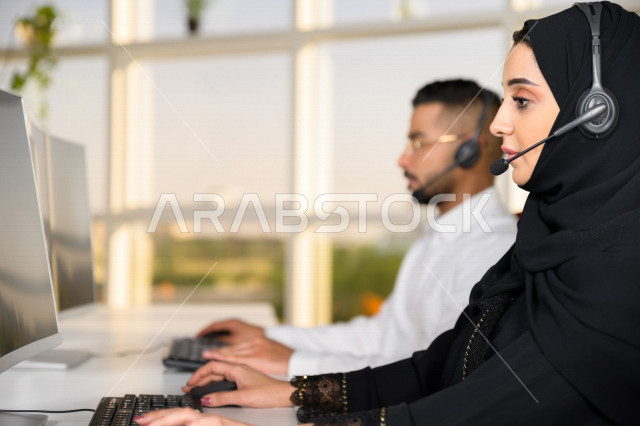 Two Saudi Arabian Gulf employees working in customer service, an ...