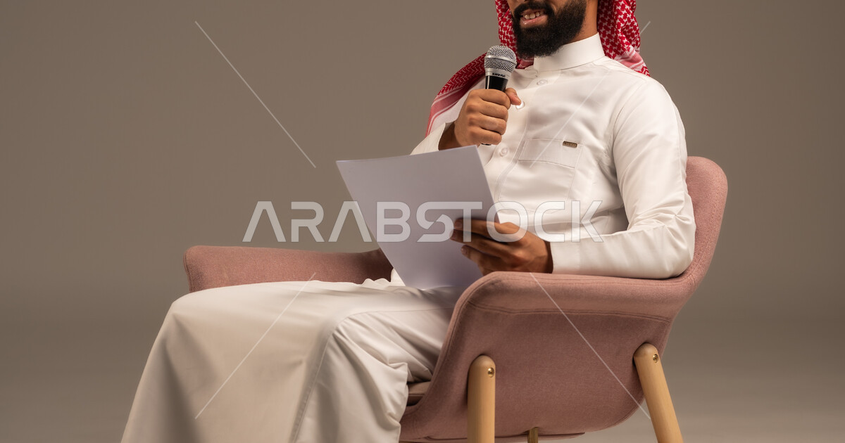 Reading notes and information, portrait of a Saudi Arabian Gulf man ...