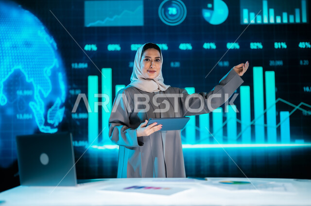 Stock market charts, veiled Saudi Arabian Gulf businesswoman wearing ...