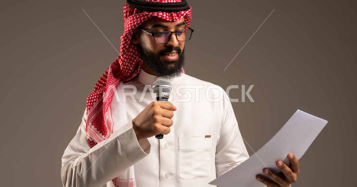 Reading notes and information, close-up portrait of a Saudi Arabian ...