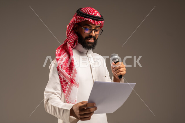 Reading notes and information, close-up portrait of a Saudi Arabian ...