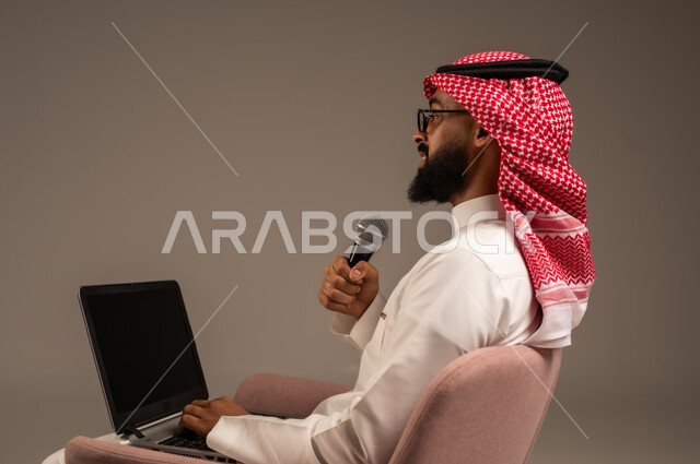 Using modern technology devices, close-up side portrait of a Saudi ...