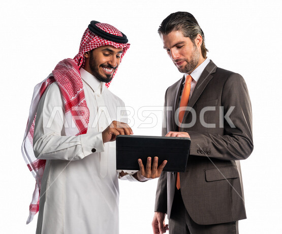 Portrait of a Gulf Saudi man in traditional Saudi dress, next to him is ...