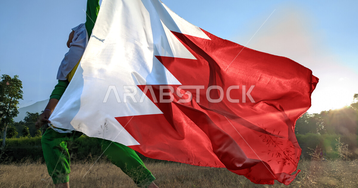 Celebrating Bahrain National Day December 16, a Bahraini Arab boy ...