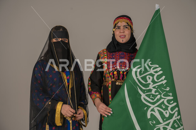 Celebrating national holidays, portrait of two Saudi Arabian Gulf women ...