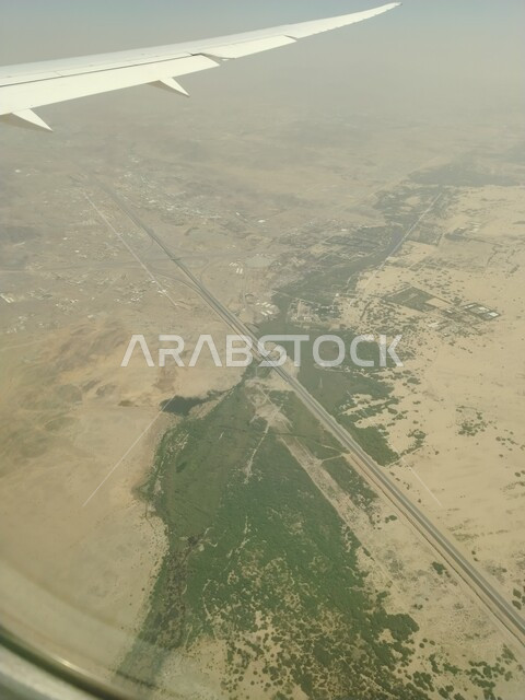 Saudi Airlines, a shot from the plane window of nature and roads in the ...