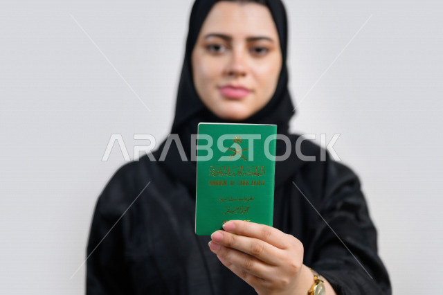 Portrait of a Saudi Arabian Gulf woman wearing a Gulf abaya holding the ...