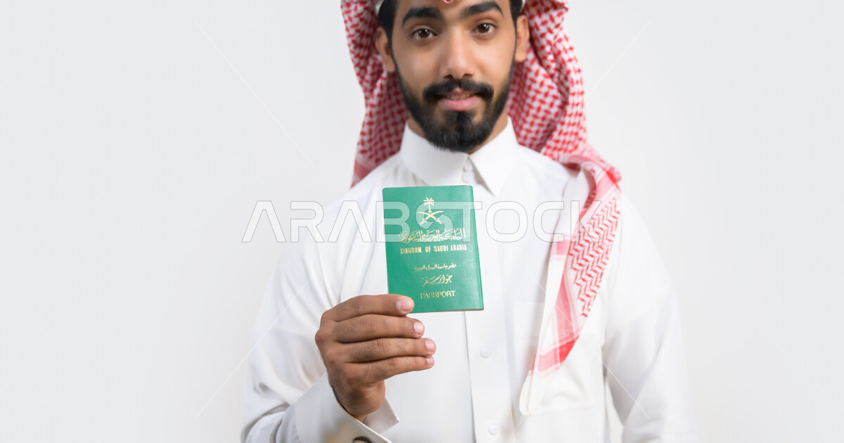 Portrait of a Saudi Arabian Gulf Arab man holding the Saudi passport ...