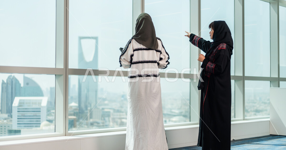 Two Saudi Arabian Gulf women looking at the city of Riyadh, a view of ...