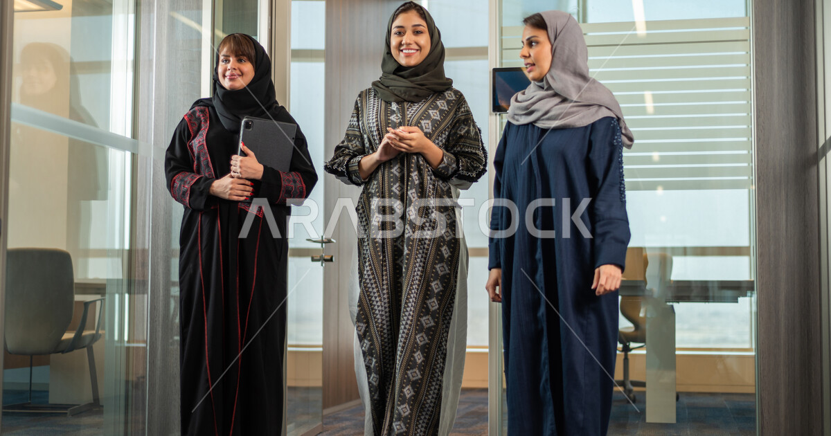 A group of Saudi Arabian Gulf female employees walking inside a Saudi ...