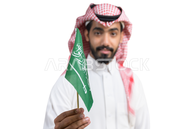 Portrait of a Saudi Arabian Gulf man holding the flag of Saudi Arabia ...