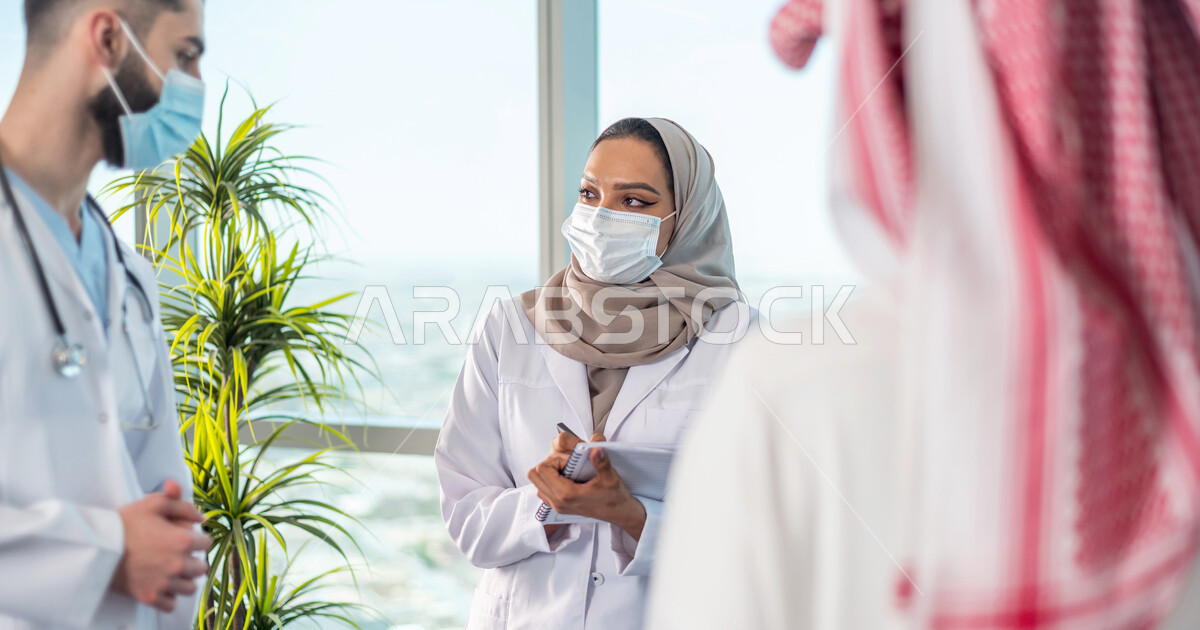 A picture of a Saudi Arabian Gulf medical team, discussing work tasks ...