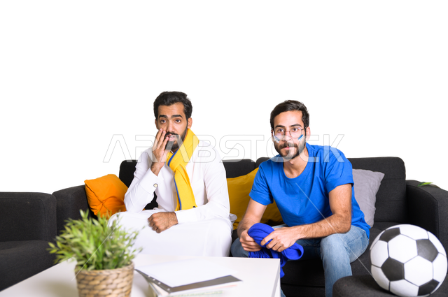 Two Saudi Arabian Gulf friends watching a Saudi league match, a young ...