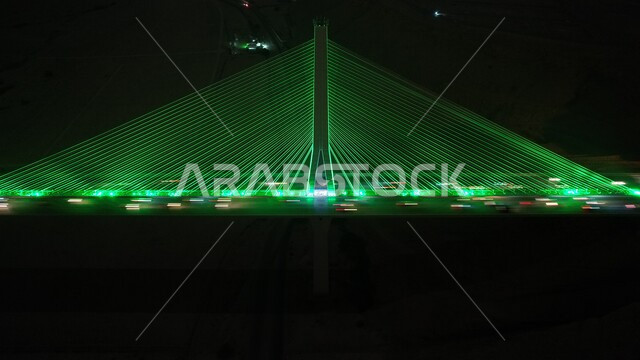 An aerial view of the cable-supported Riyadh suspension bridge at night ...