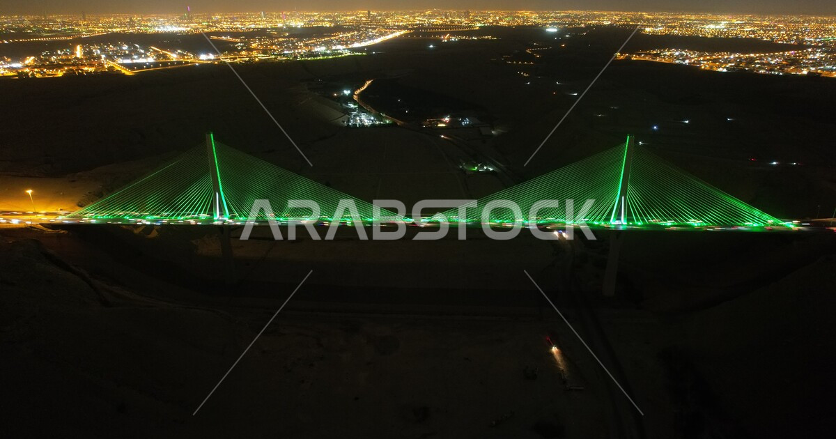 An aerial view of the cable-supported Riyadh suspension bridge at night ...