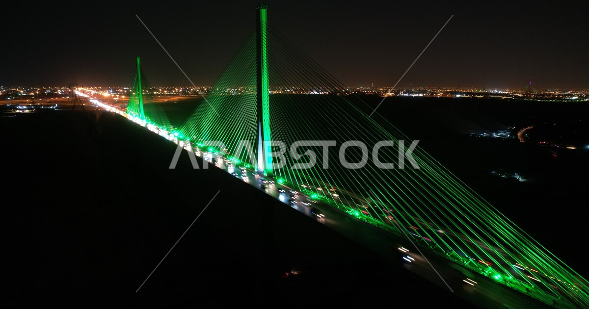 An aerial view of the cable-supported Riyadh suspension bridge at night ...