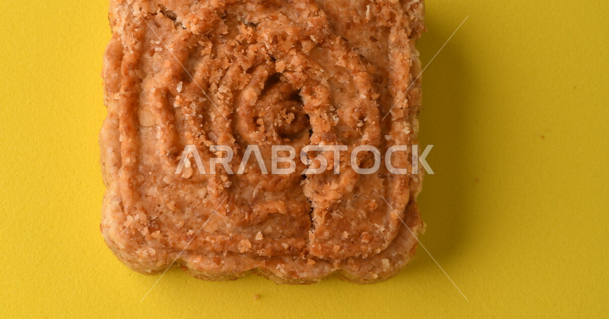 Close-up of a maamoul filled with dates, a square shape of a delicious ...
