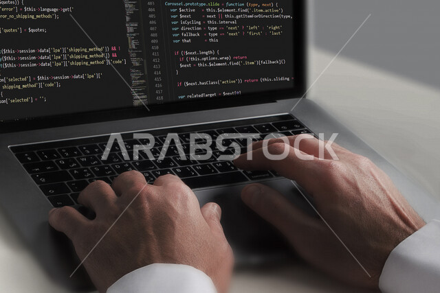 A young Saudi Gulf working as a web developer, using programming ...