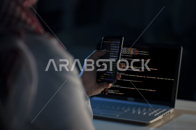 A young Saudi Gulf working as a web developer, using programming ...