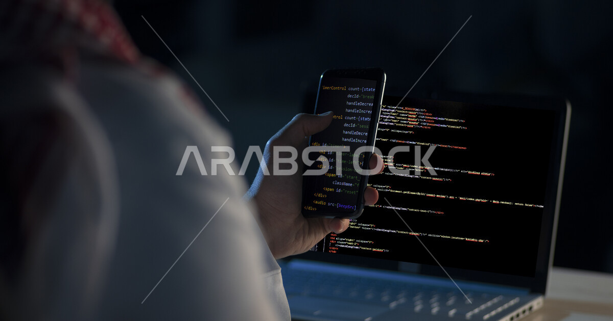 A young Saudi Gulf working as a web developer, using programming ...