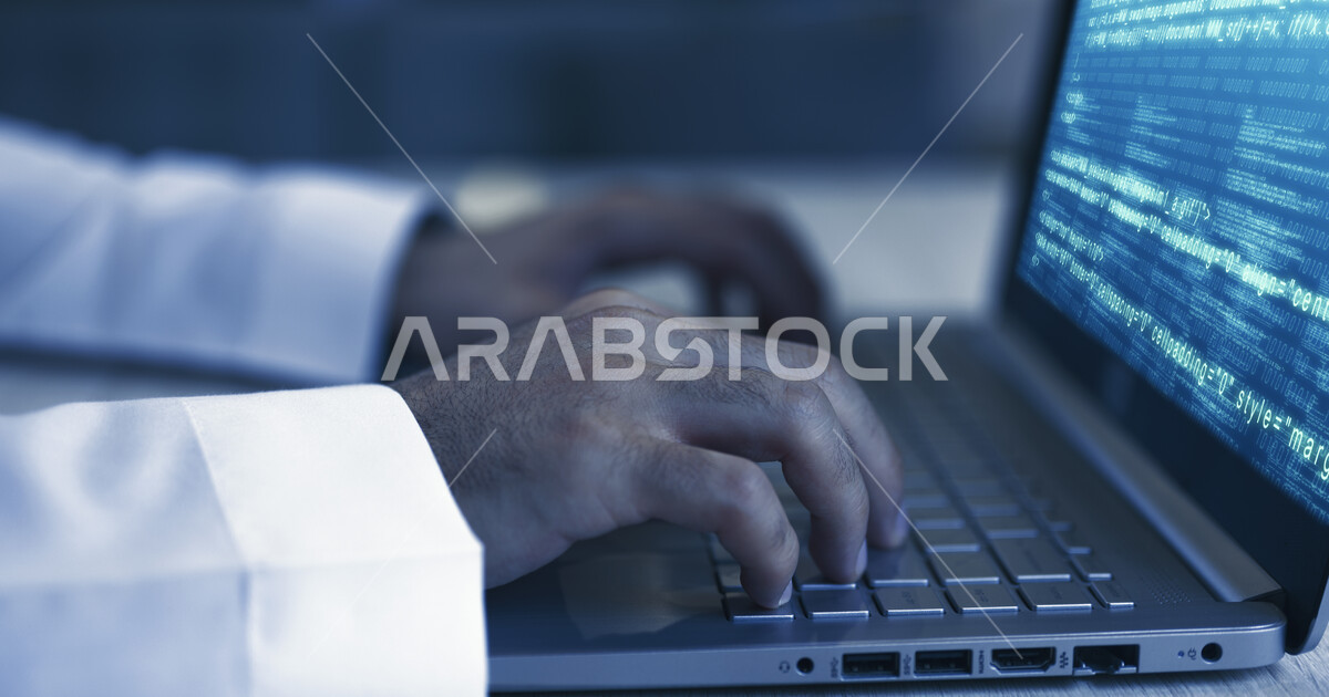 A young Saudi Gulf working as a web developer, using programming ...