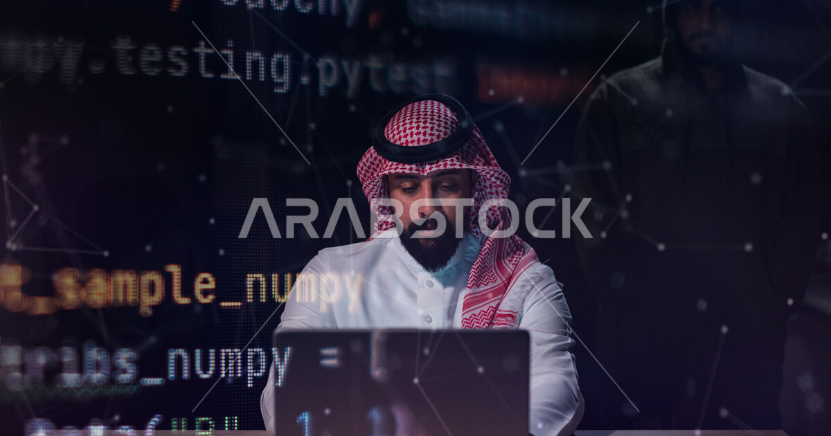 A Saudi Arabian Gulf businessman, working to protect his laptop from ...