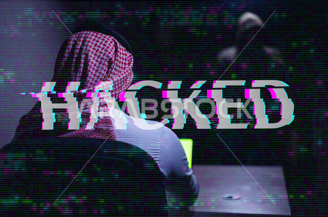 A Saudi Arabian Gulf businessman, working to protect his laptop from ...