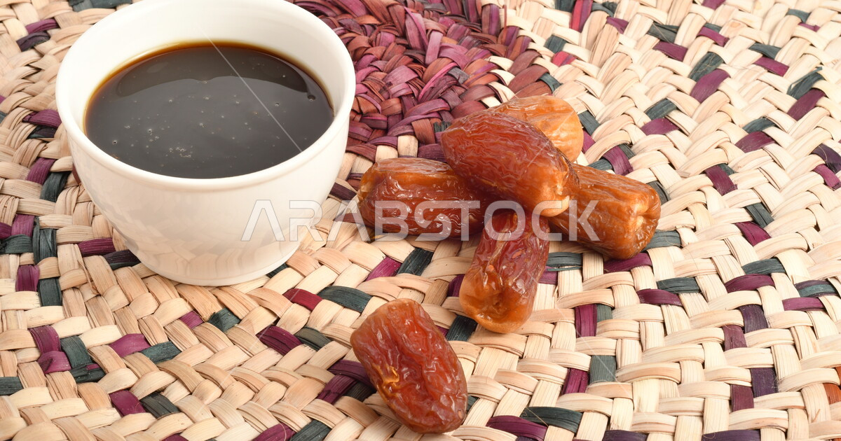 Picture of a group of dates beside a bowl of healthy date molasses ...