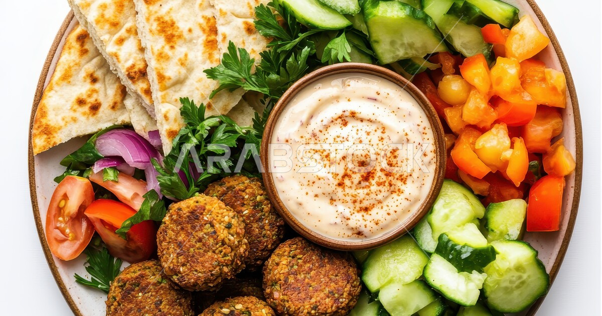 A plate of crispy fried falafel discs with vegetables, Saudi Arabian ...