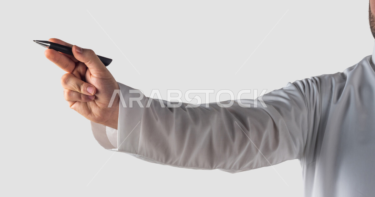 Portrait of a Saudi Gulf man wearing traditional Gulf dress holding a ...