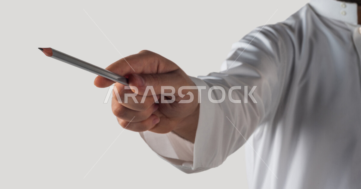 Portrait of a Saudi Gulf man wearing traditional Gulf dress holding a ...