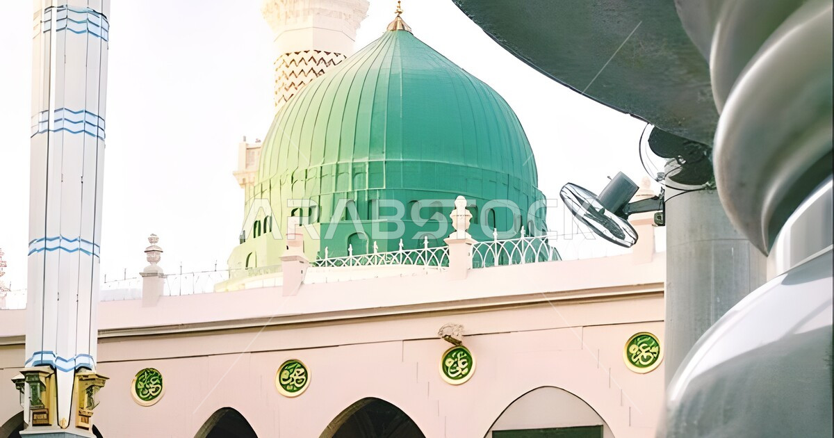 Muslims sitting in the outer complex of the Prophet's Mosque in Medina ...