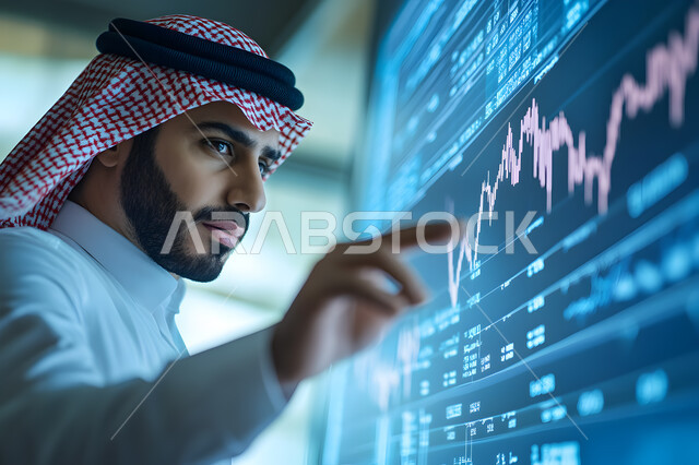 Cryptocurrency trading, close-up side view of a Saudi Arabian Gulf businessman wearing a red ...