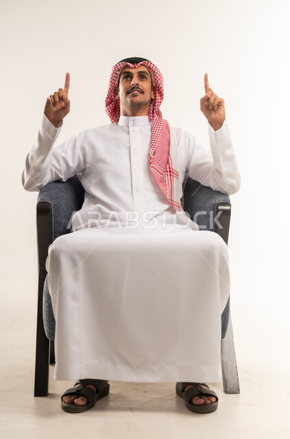 Pointing and explaining something, portrait of a Bahraini Gulf Arab man ...