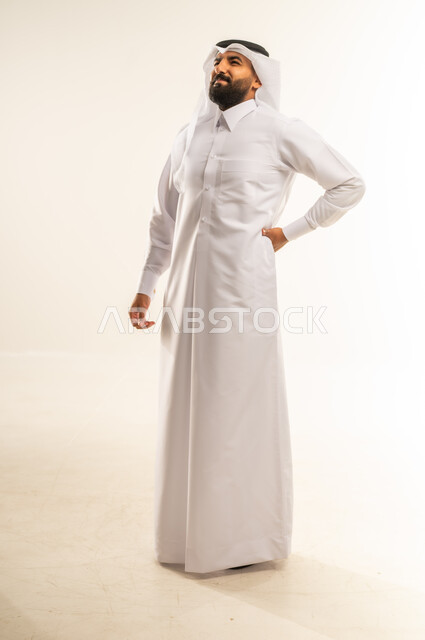 Back and spine pain, portrait of a Qatari Gulf Arab man wearing a ...
