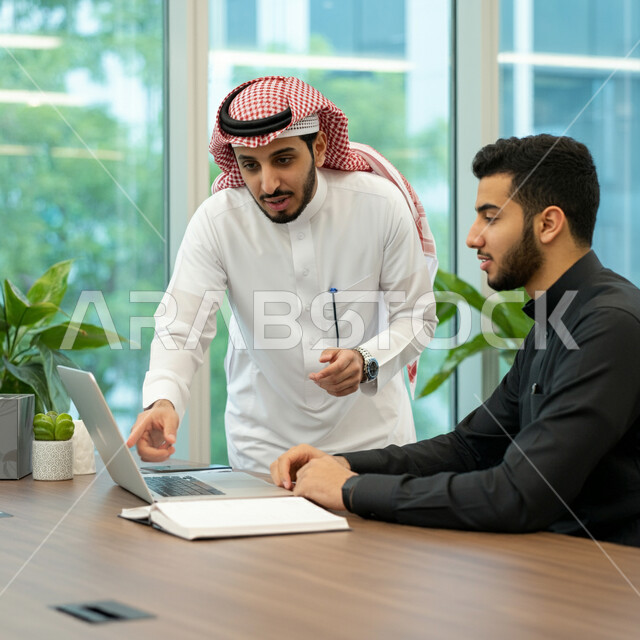 Using modern devices and technologies in office work, two Saudi Gulf ...
