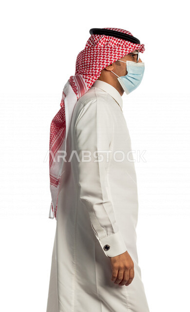 Portrait of a Saudi Arabian Gulf man wearing a protective medical mask ...