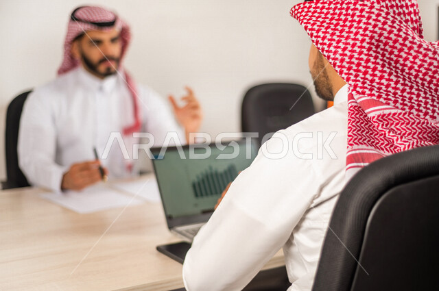 Meeting of Saudi-Arab Gulf co-workers at their workplace, discussing ...