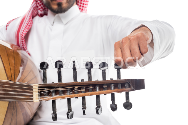A close-up of a Saudi Arabian Gulf man playing the oud, musical ...