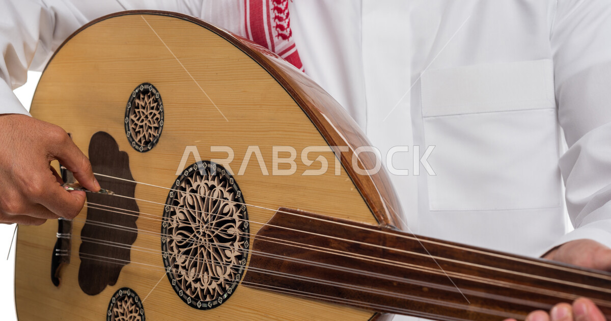 A close-up of a Saudi Arabian Gulf man playing the oud, musical ...