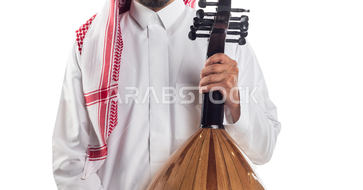 A close-up of a Saudi Arabian Gulf man holding in his hands the oud ...