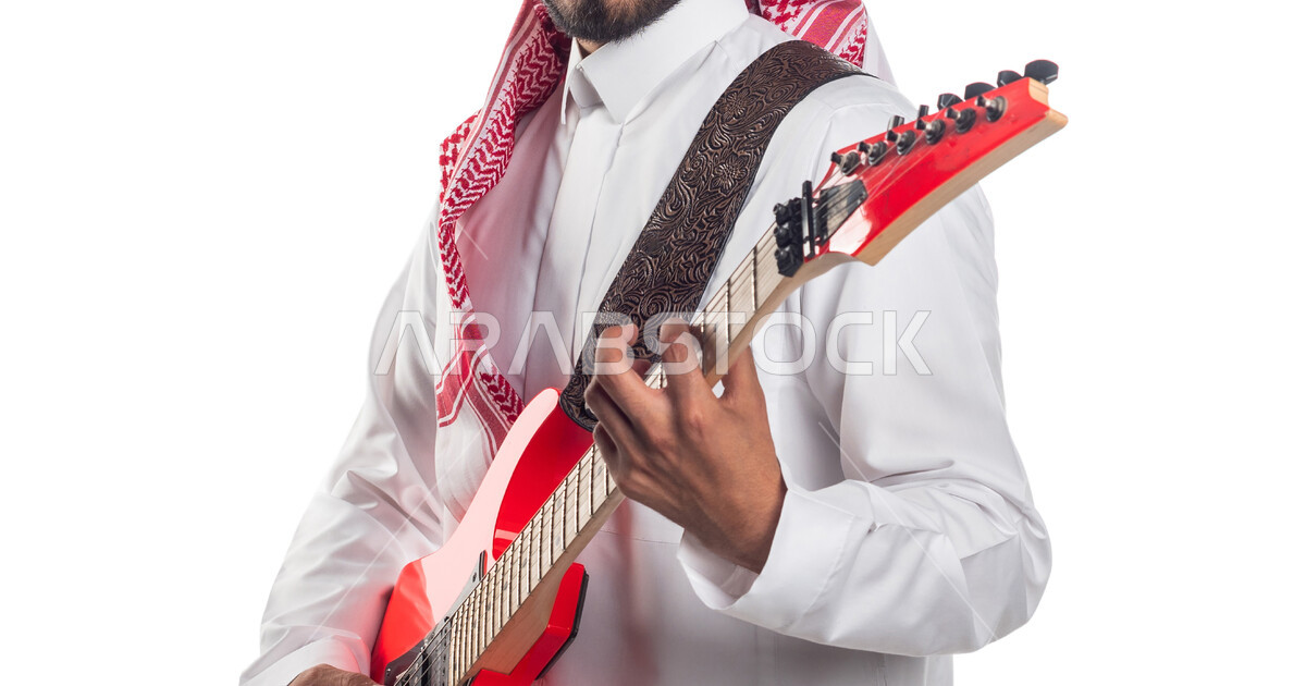 A portrait of a Saudi Arabian Gulf man playing the electric guitar ...