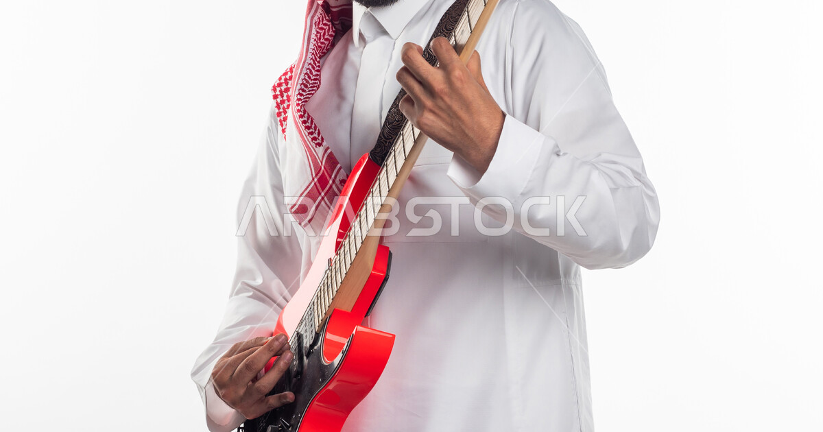 A portrait of a Saudi Arabian Gulf man playing the electric guitar ...