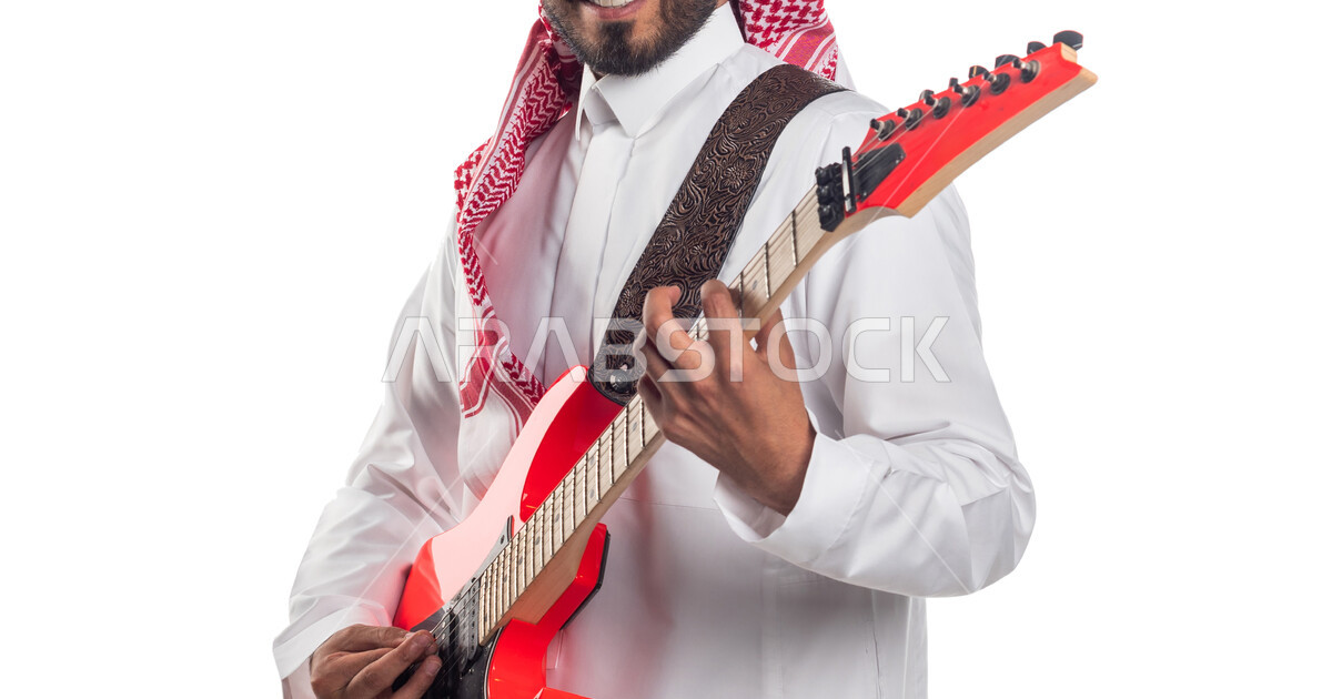 A portrait of a Saudi Arabian Gulf man playing the electric guitar ...