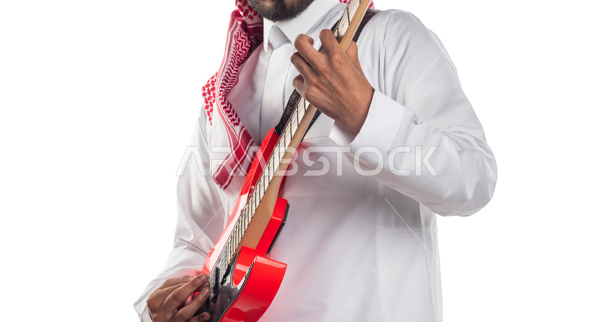 A portrait of a Saudi Arabian Gulf man playing the electric guitar ...