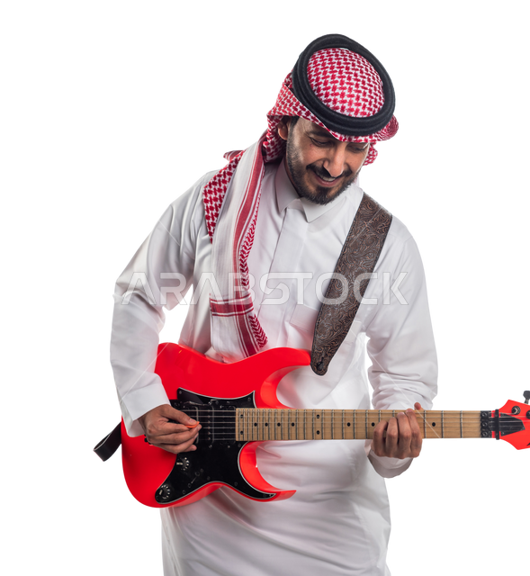 A portrait of a Saudi Arabian Gulf man playing the electric guitar ...
