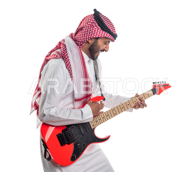 Portrait of a Saudi Arabian Gulf man playing the electric guitar ...